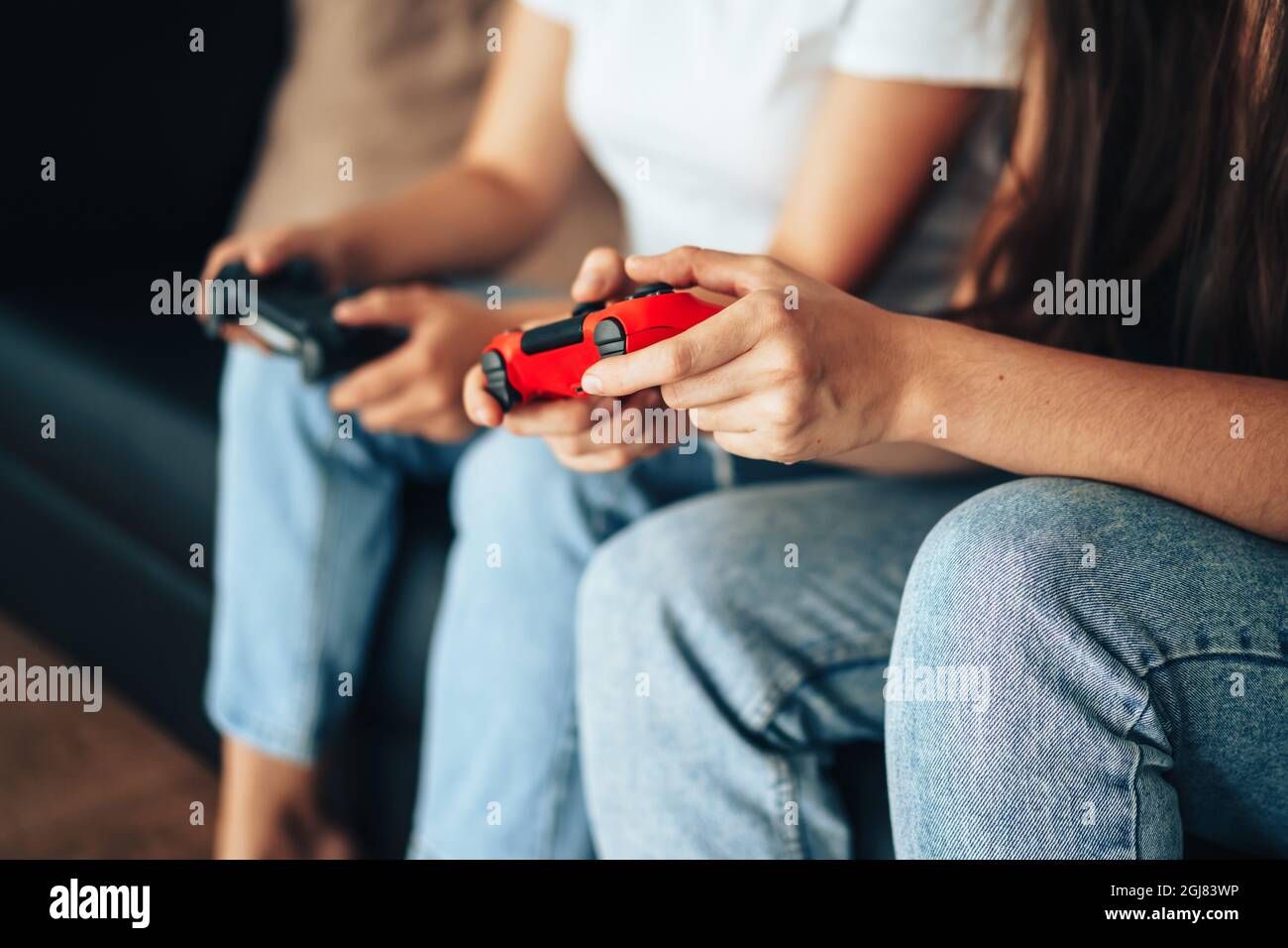 Girls holding gamepads and playing video games on the console Stock ...