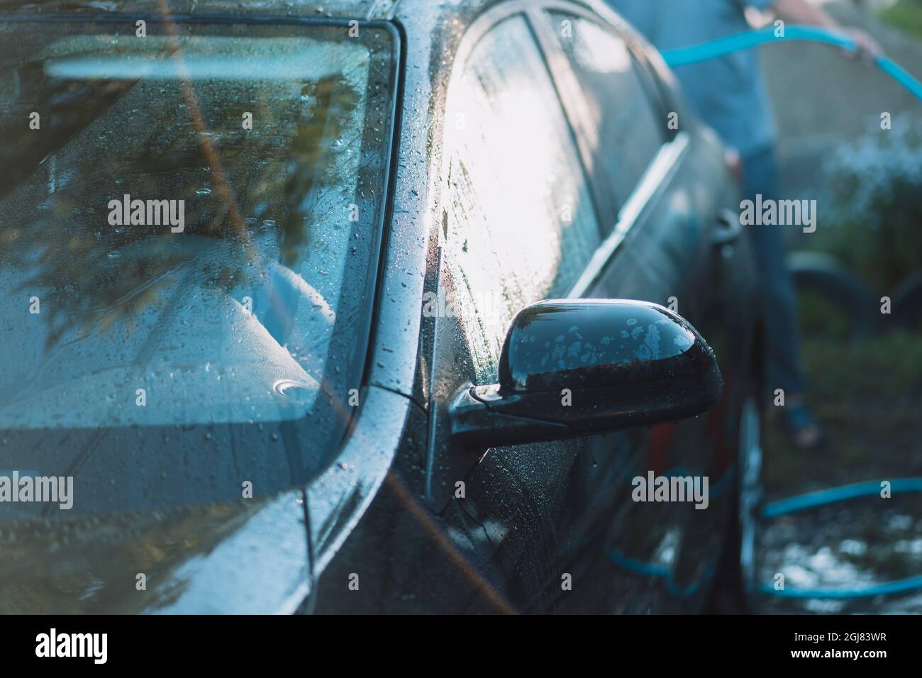Machine in drops of water doused with hose Stock Photo - Alamy