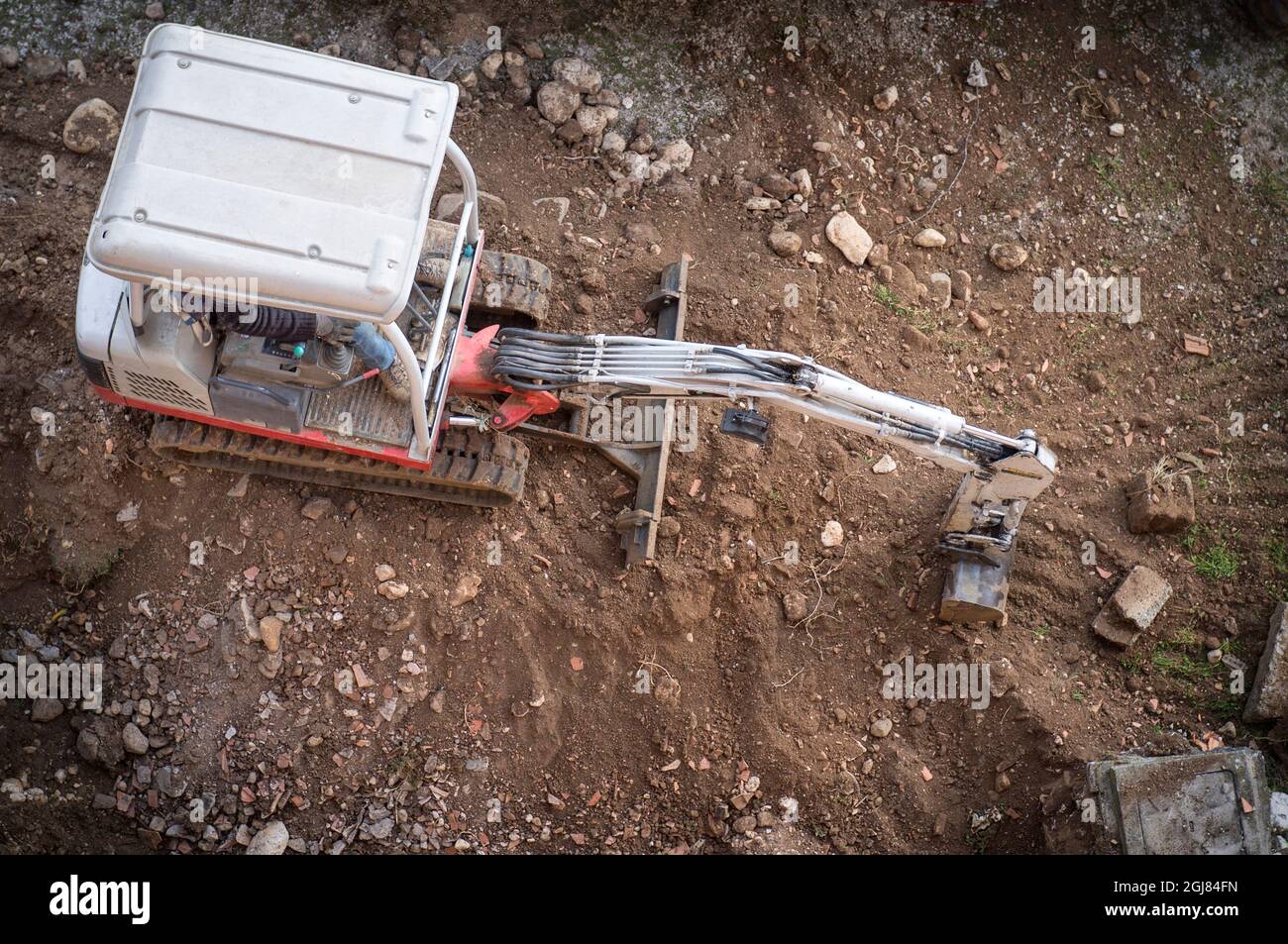 Mini excavator, seen from above, removing earth Stock Photo - Alamy