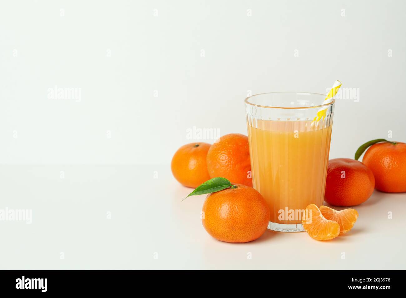 Glass of mandarin juice and ingredients on white background Stock Photo ...