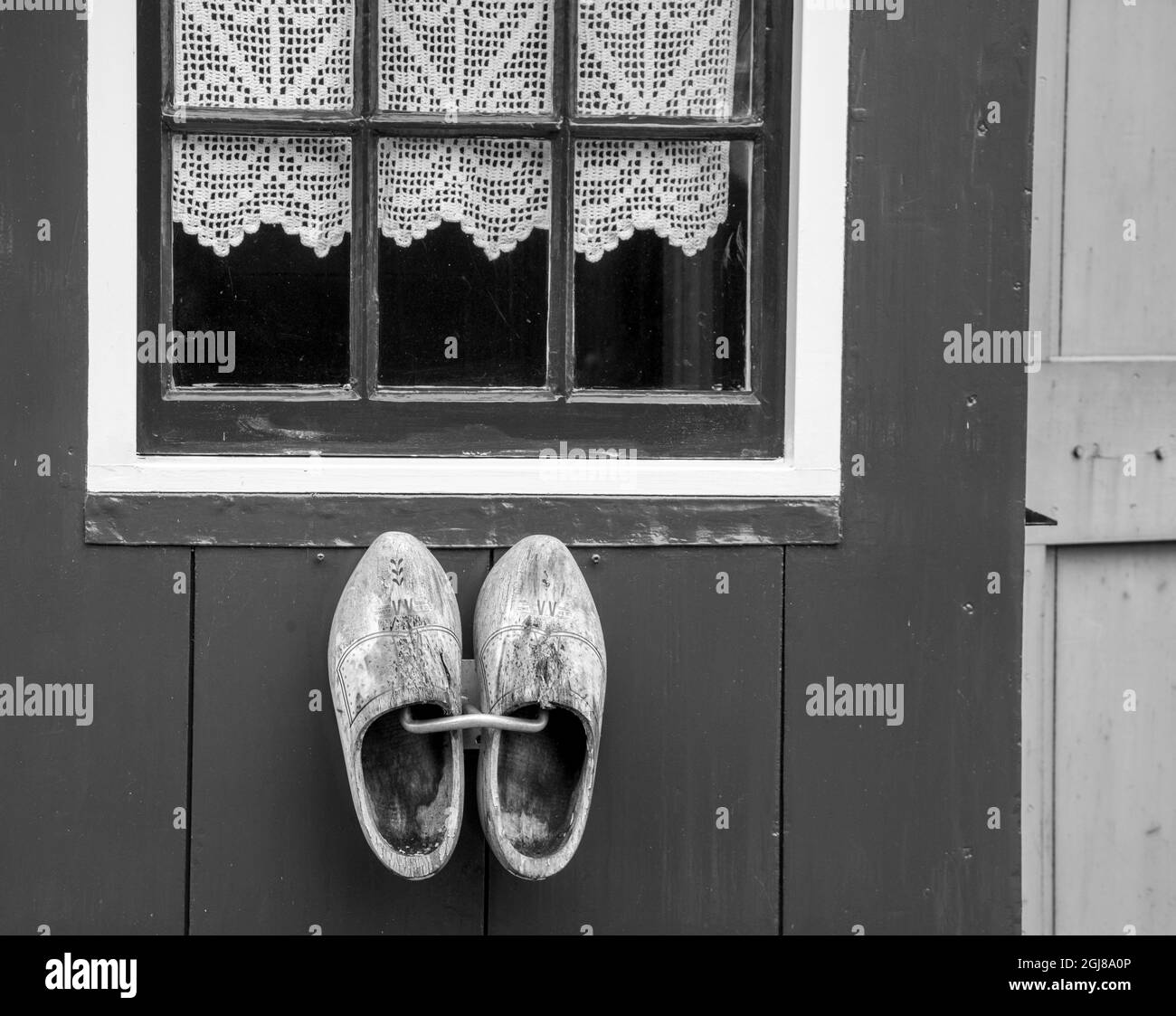 Shoes on wall Black and White Stock Photos & Images - Alamy