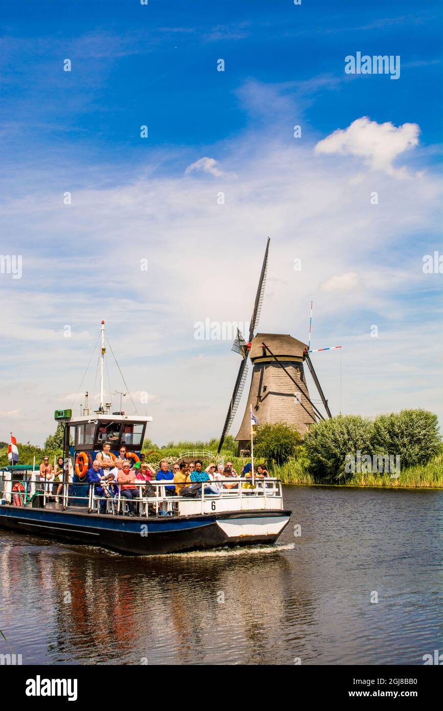 Canal tour boat and windmill in Unesco World Heritage Site, Kinderdijk ...