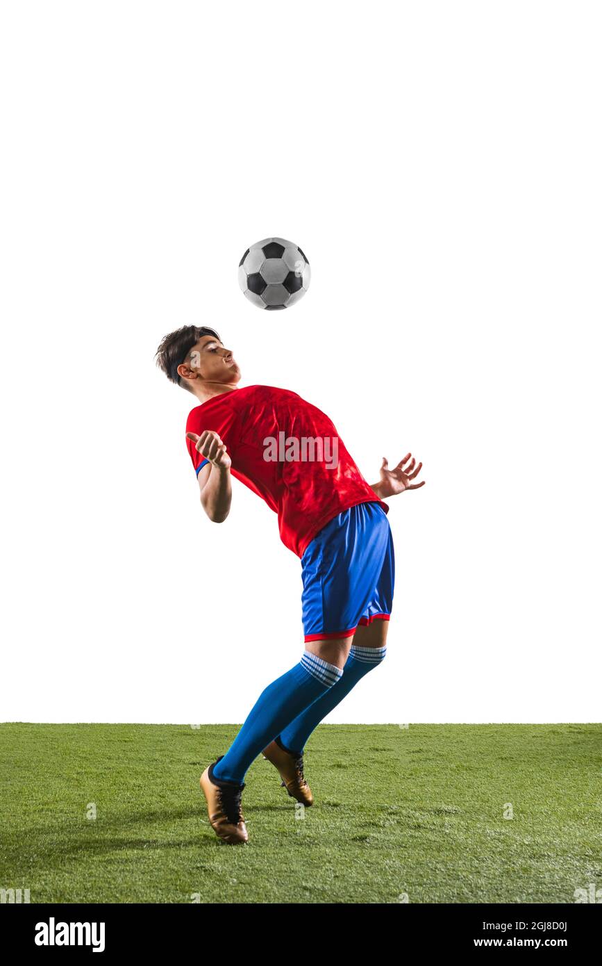 Full-length portrait of one male soccer football player clearing ball ...