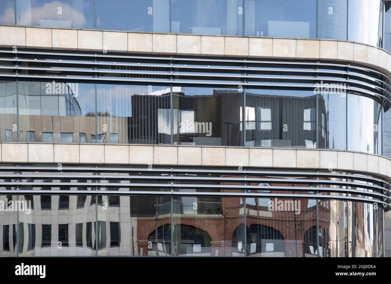 Image depicting buildings being reflected in a modern, glass office ...