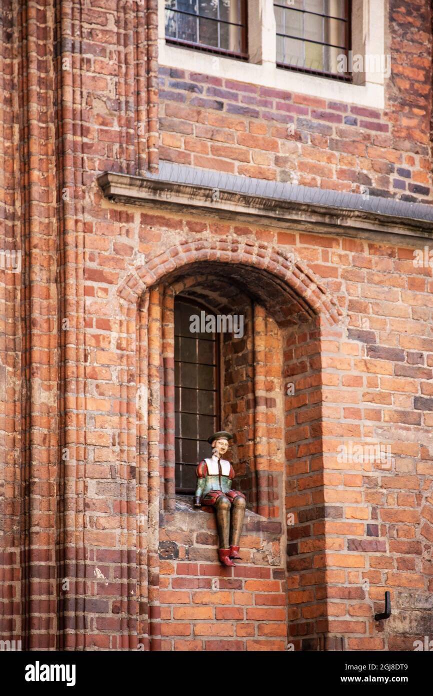 Placed in various windows at Torun town Hall sit these manikins dressed ...