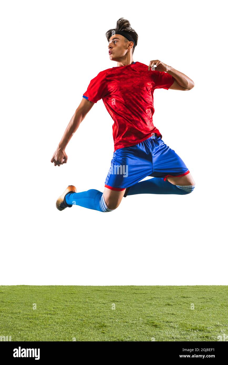 Full-length portrait of young man, male soccer football player training ...