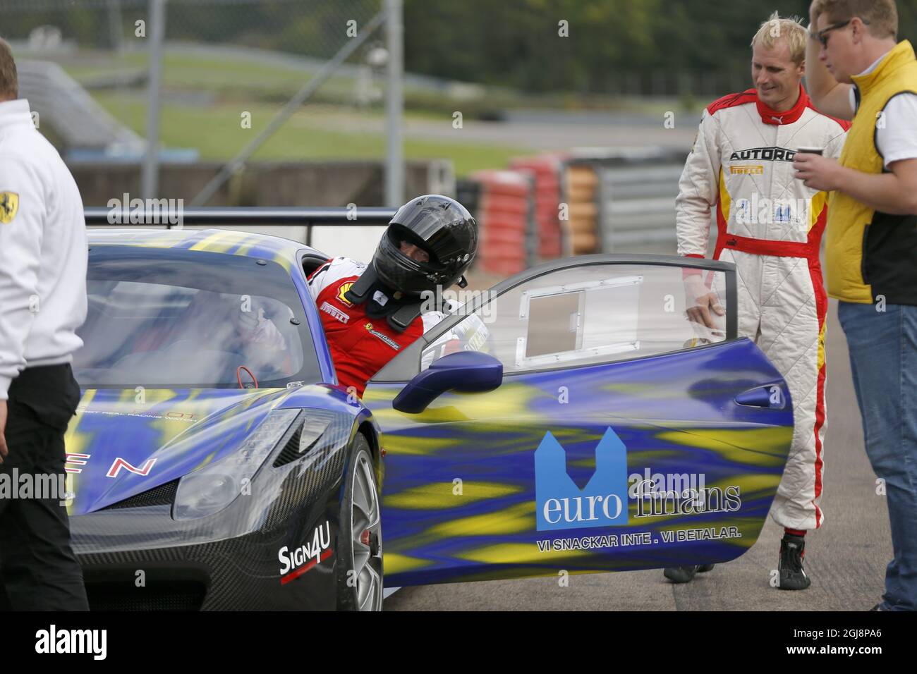 British actor Hugh Grant is seen in his Ferrari 458 Challenge Evolution ...