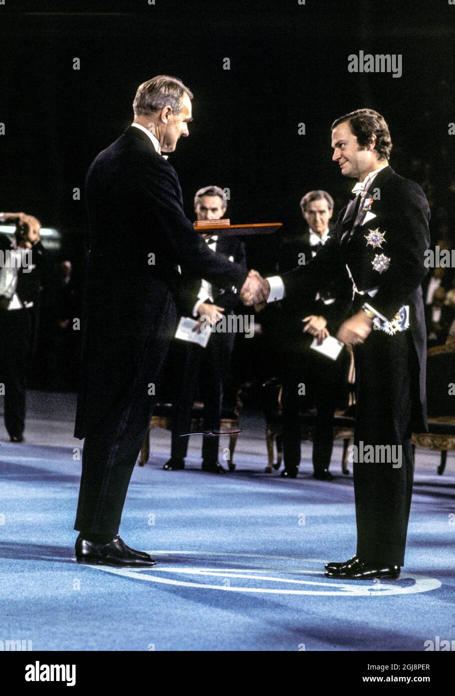 The chemist John W. Cornforth (left) receives the Nobel Prize from King ...