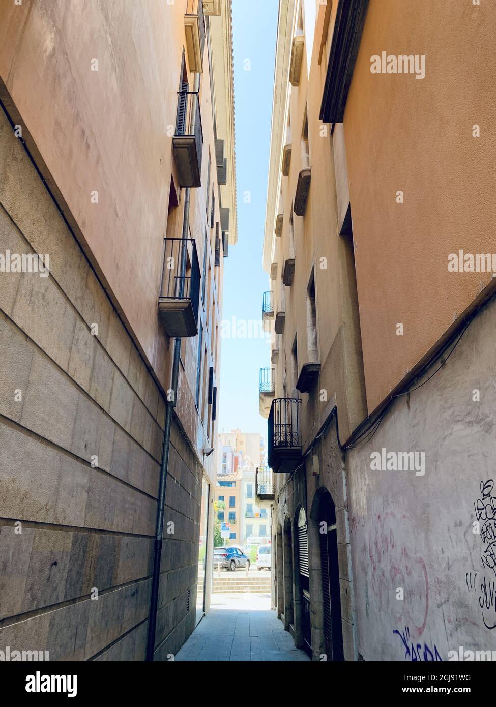 Narrow passage between two buildings leading to the sunny street Stock ...