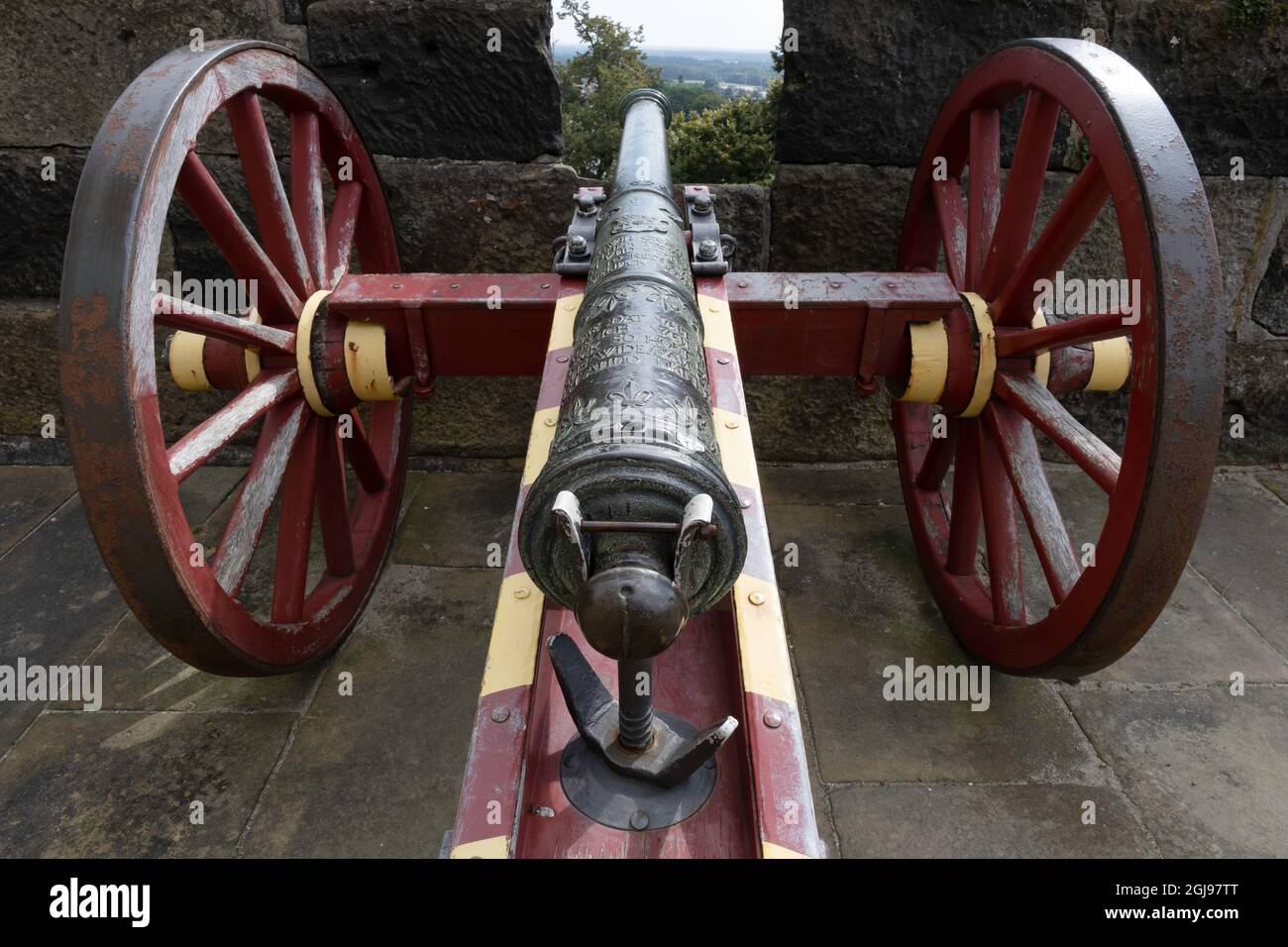 Antique cannon in red-yellow color on the defensive wall of the early ...
