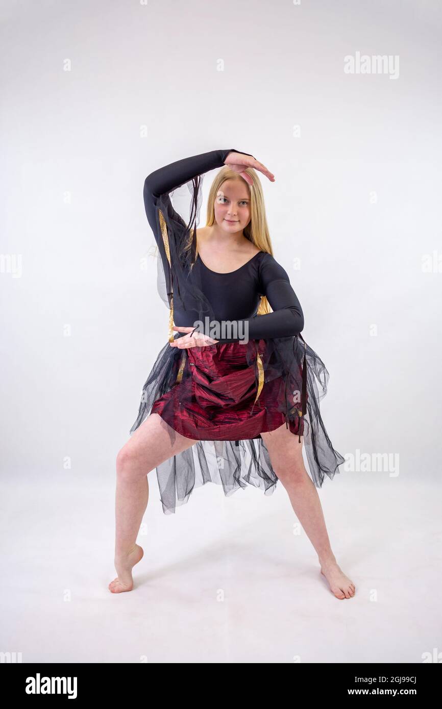 Young blonde blue-eyed dancer woman in fantasy dress on white ...