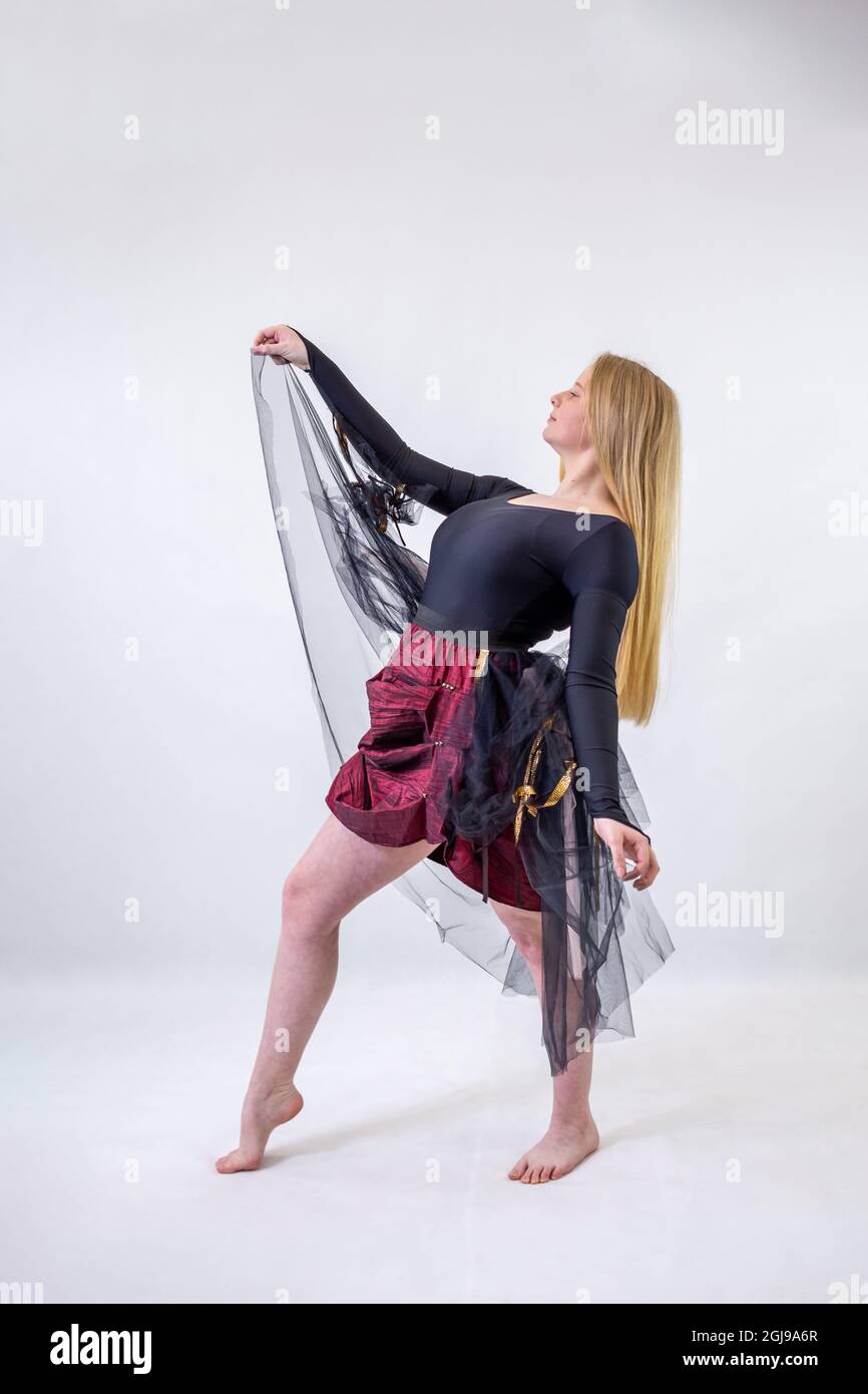 Young blonde blue-eyed dancer woman in fantasy dress on white ...