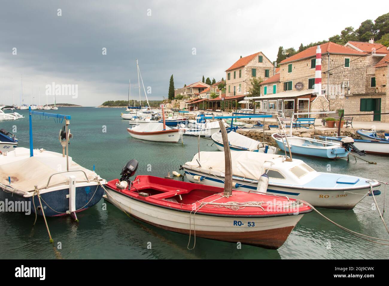 Europe, Croatia, Solta Island Maslinica inner bay colorful fishing boats and village Stock Photo ...
