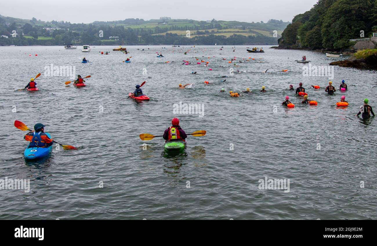 Group swimming in the sea with Kayak safety boats Union Hall, West Cork ...
