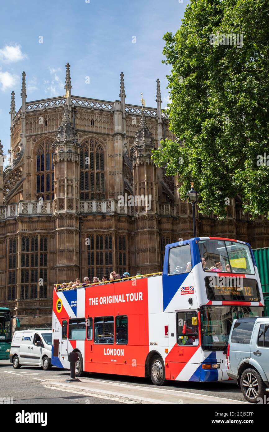 Classic double decker tour bus in London, England with Parliament House ...