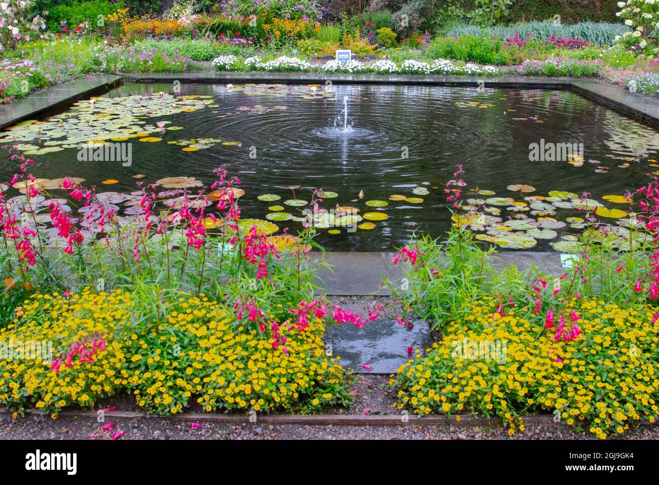 Dunvegan Castle, reflecting pool with a fountain surrounded by flower ...