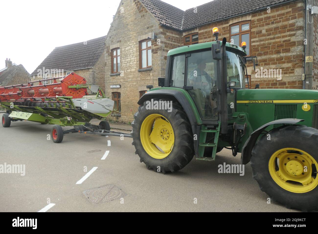 Tractor Moving farm machinery in Ringstead Northamptonshire Village UK ...