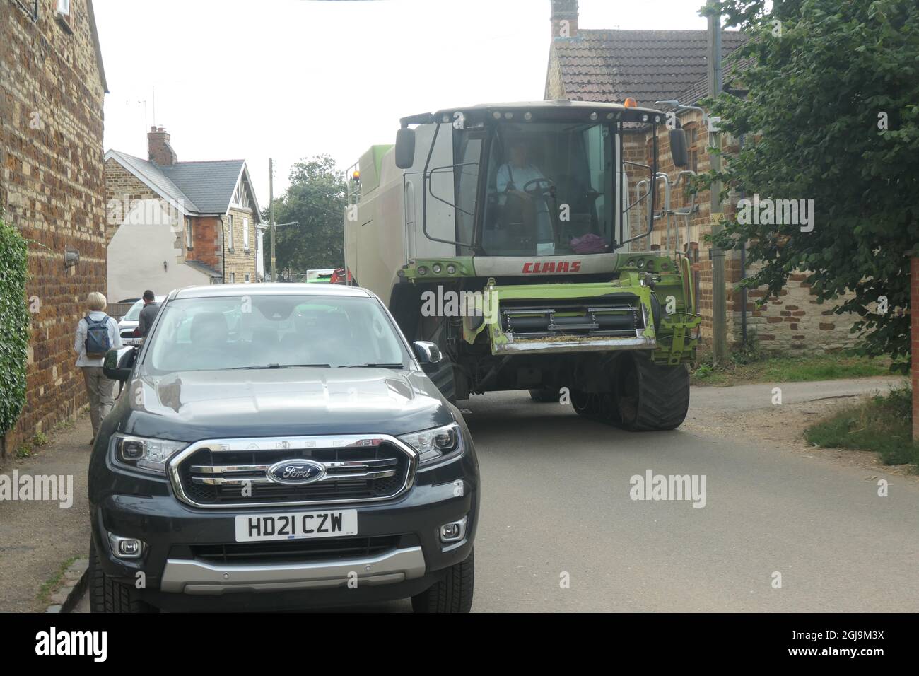 Ford car and Combine harvester Lexion 460 in Ringstead Northamptonshire ...