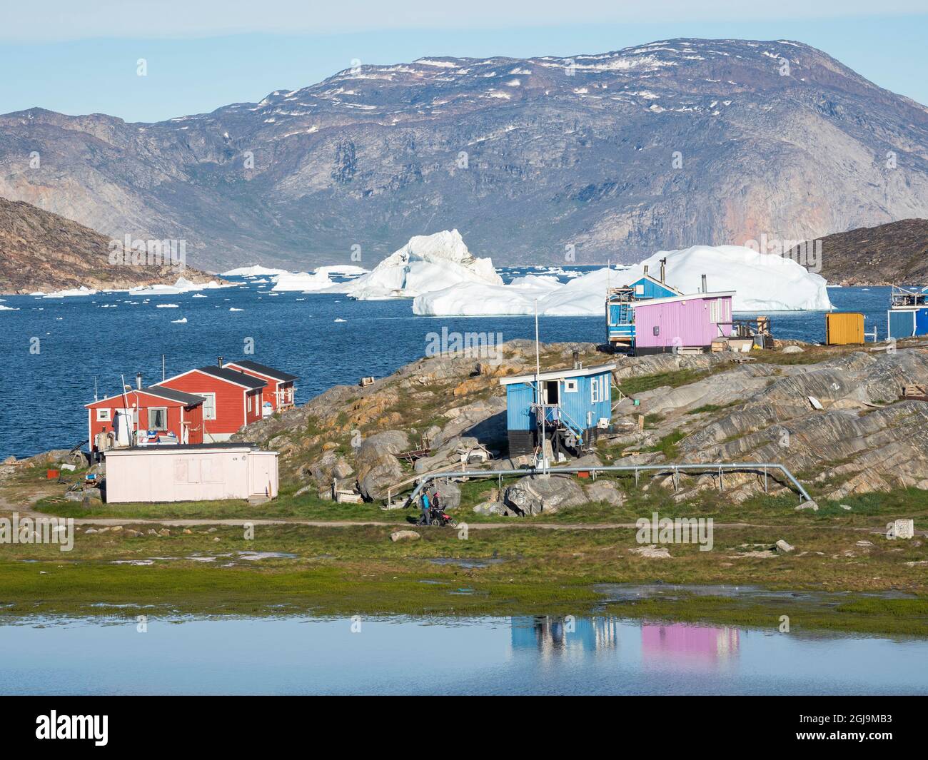 Small fishing village Ikerasak on Ikerask island in the Uummannaq Fjord ...