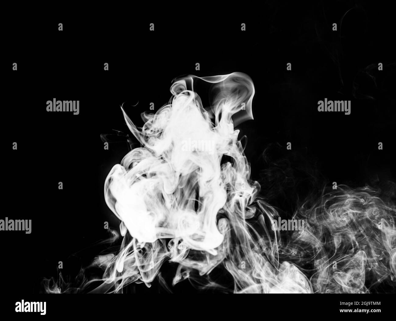 White curves of fume waves from a cigarette, isolated on black ...