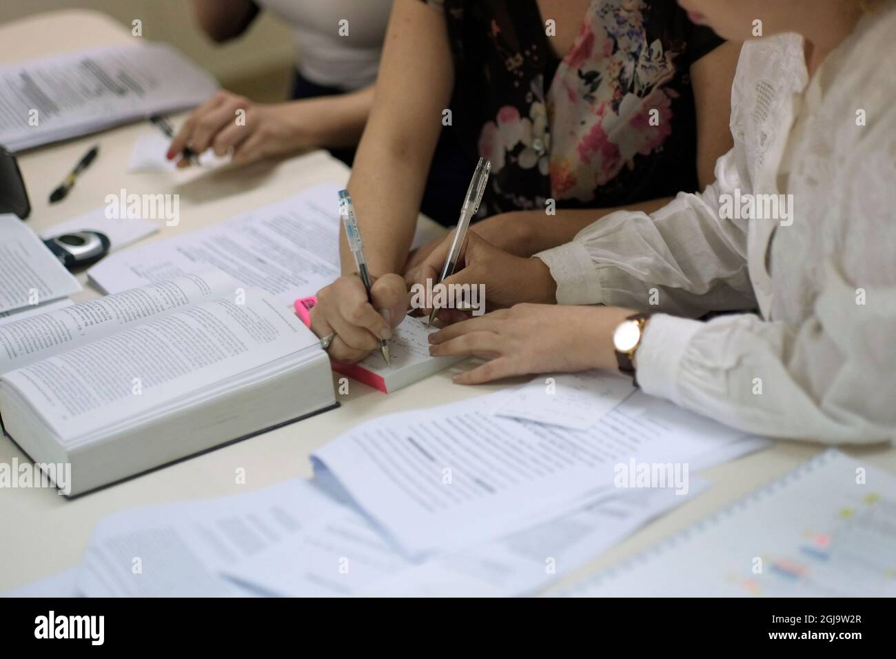 People writing during a business meeting Stock Photo - Alamy