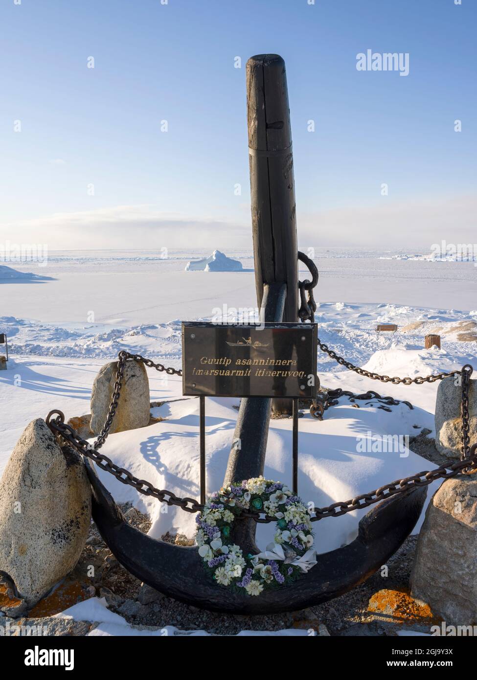Monument with an anchor. Winter in Ilulissat on the shore of Disko Bay ...