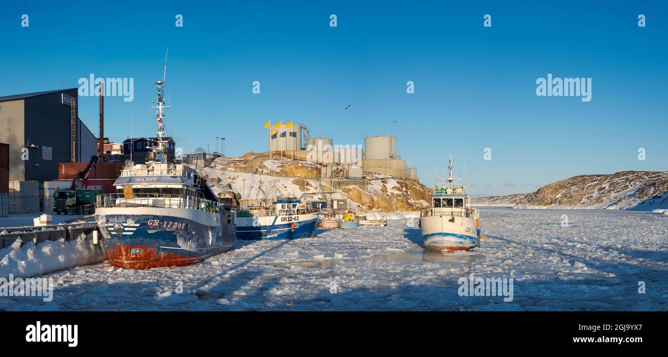 Winter in the frozen harbor of town Ilulissat on the shore of Disko Bay ...