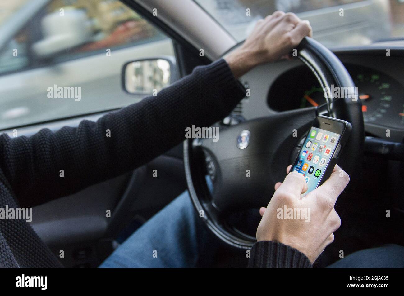 STOCKHOLM 2012-01-02 Driving, driver sending sms while driving, wheels ...