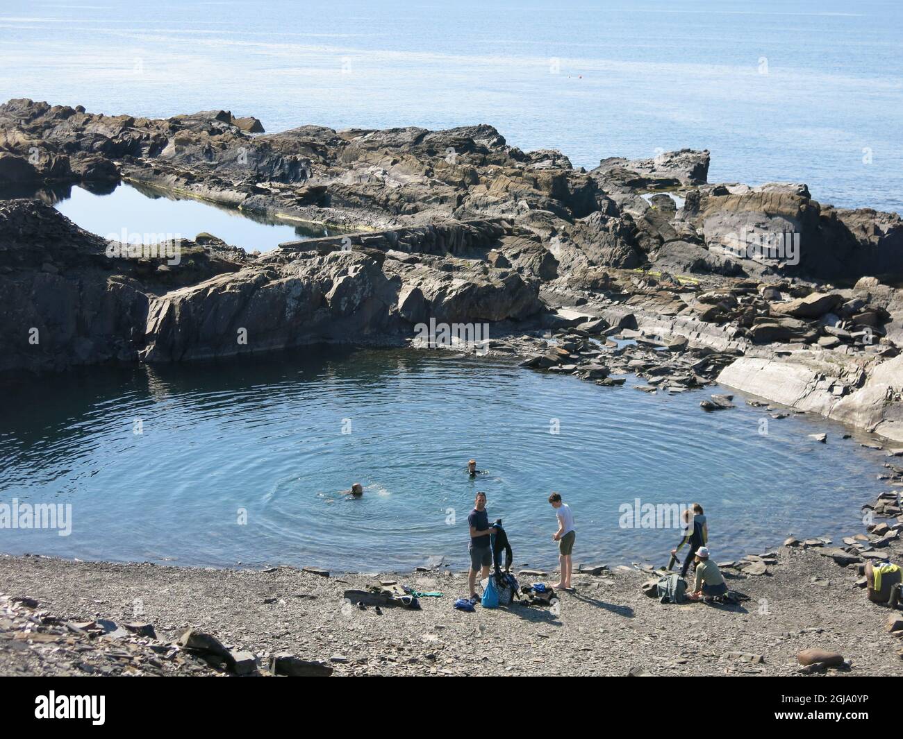 Rock pools formed from the former slate quarries on Easdale Island now ...