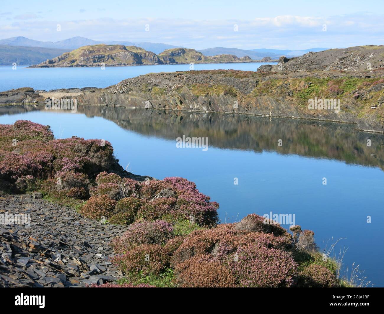 Deep pools of clear blue water in disused slate quarries, Easdale ...