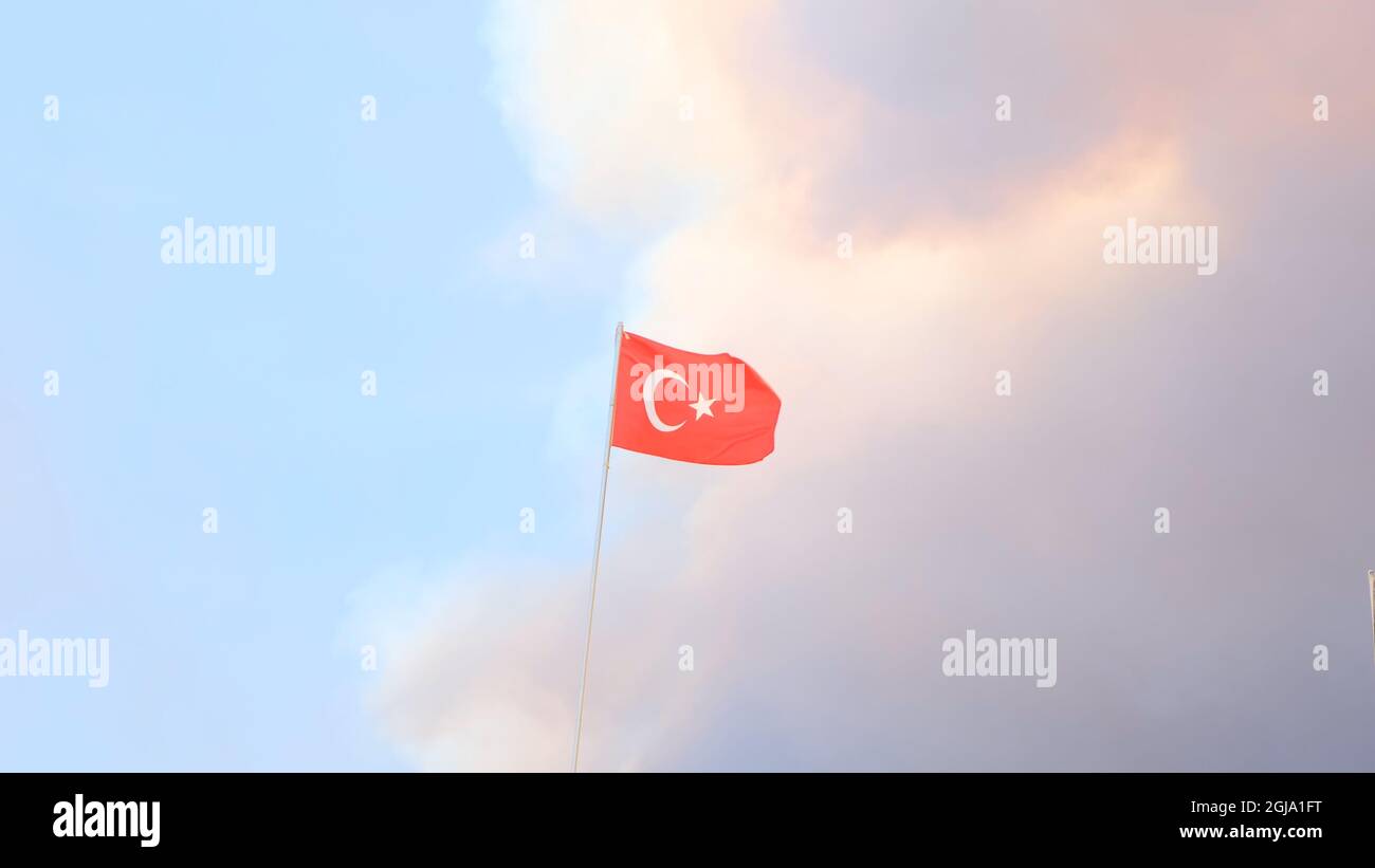 Turkey flag close-up on a background of forest fire smoke clouds ...