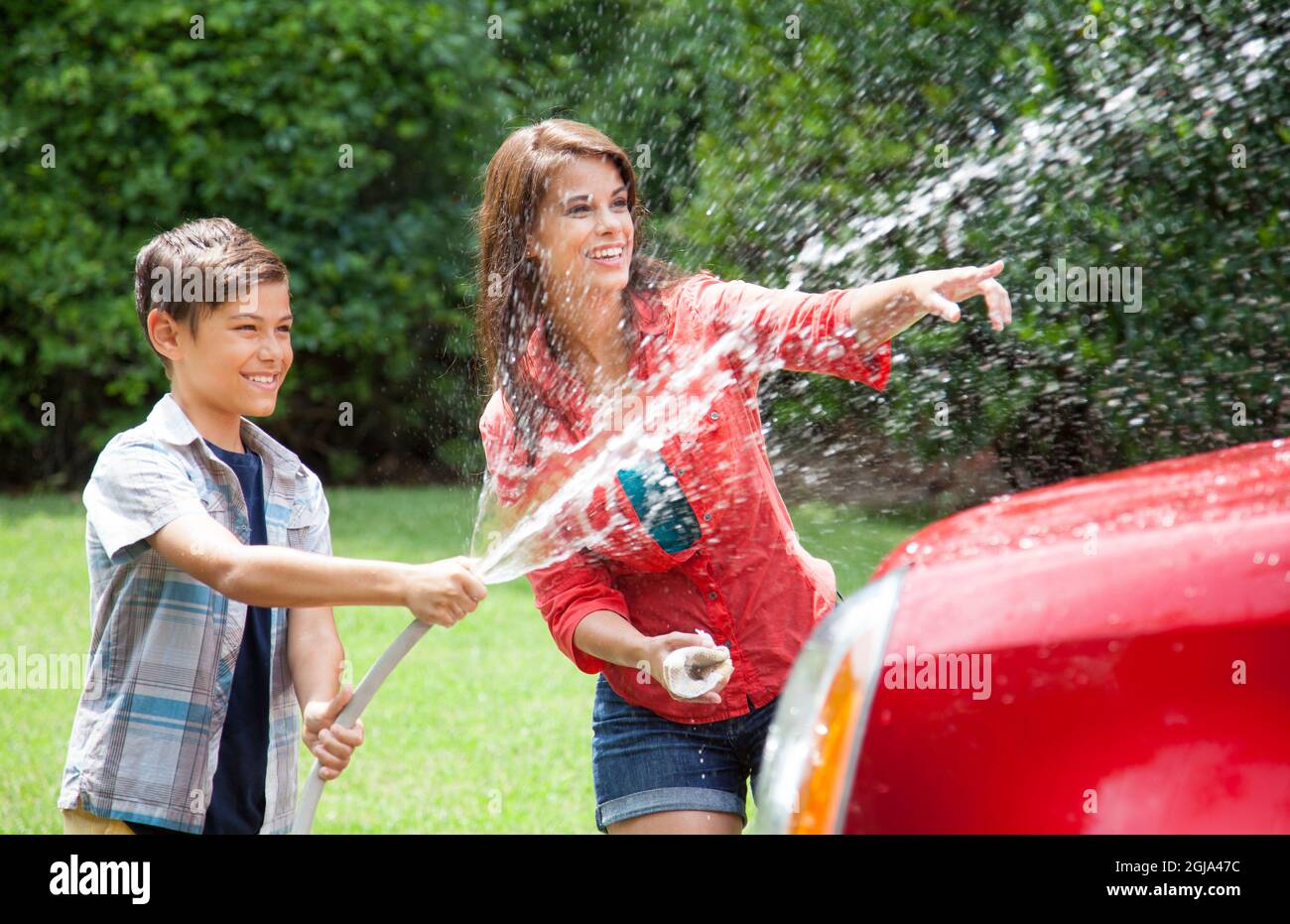 Family washing car together in driveway of home (MR Stock Photo - Alamy