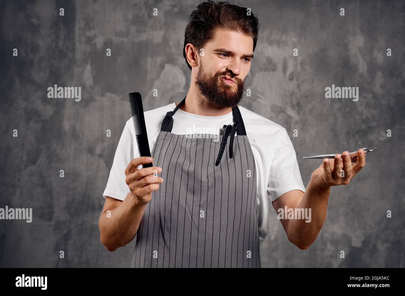 bearded male hairdresser in apron comb scissors service Stock Photo - Alamy