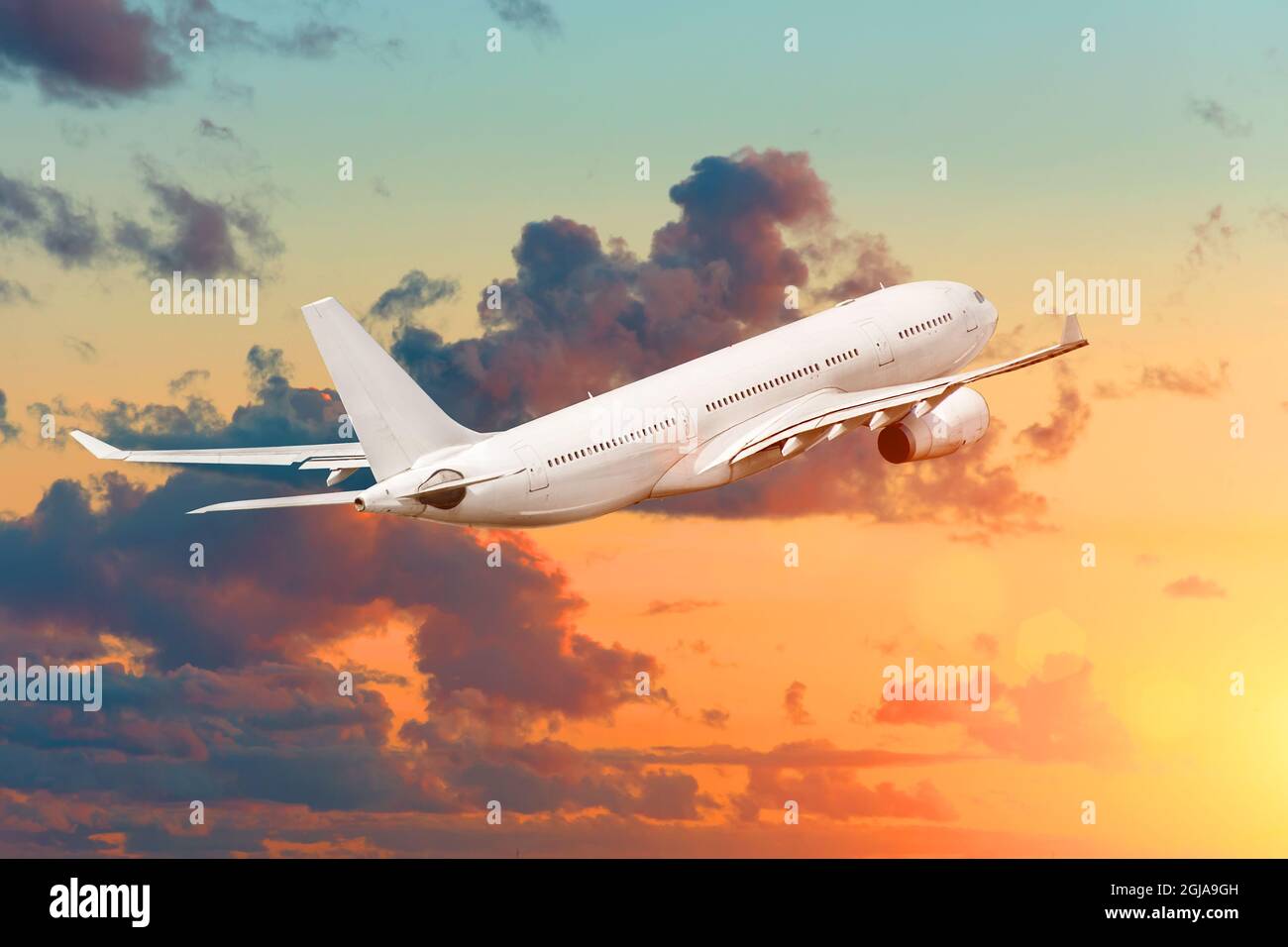 Bright colorful sky and a flying airplane at sunset Stock Photo - Alamy