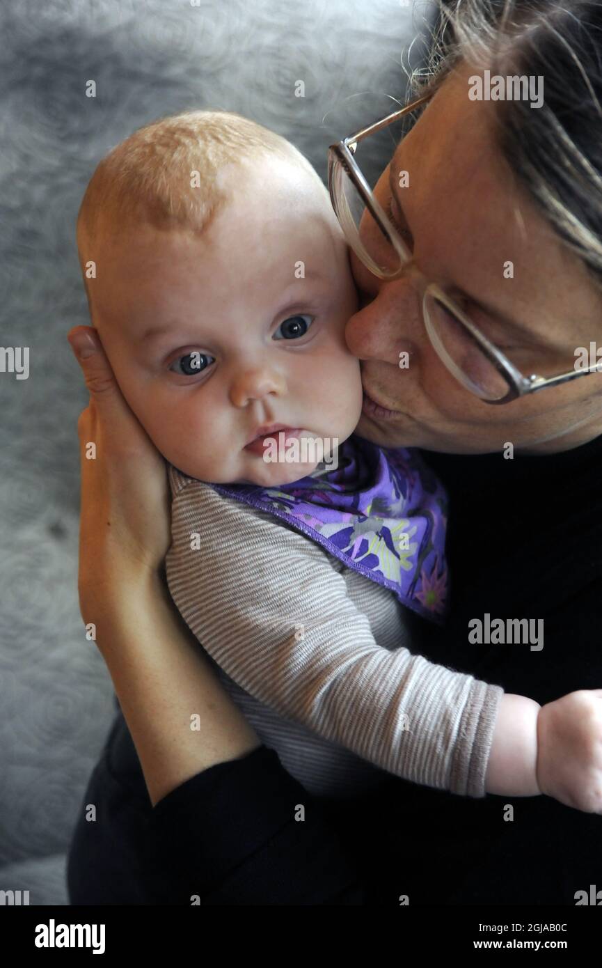 STOCKHOLM 2016-10-21 Mother kissing and hugging her five-month old ...