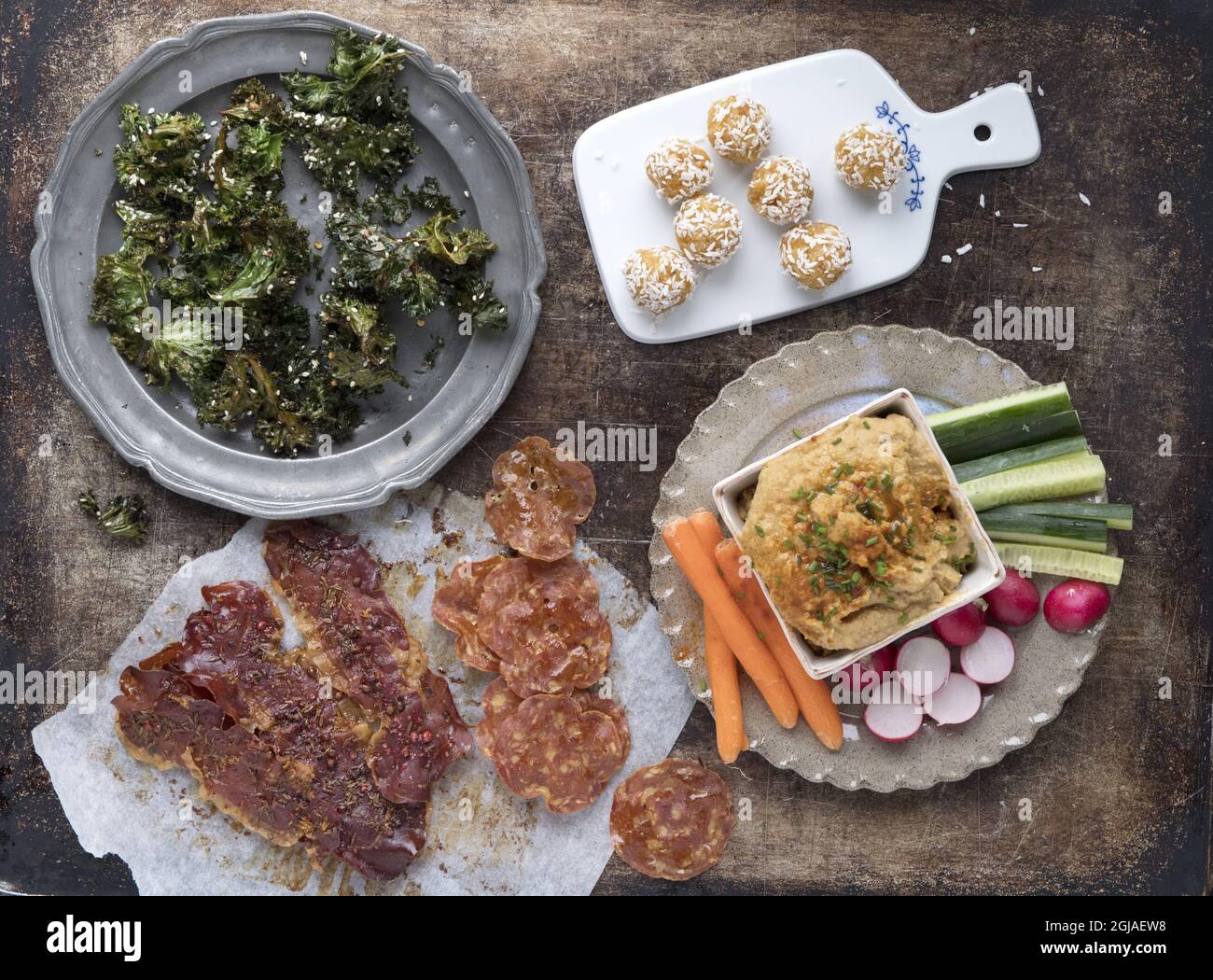 STOCKHOLM 20161103 Homemade snacks. Kale Chips, oven-dried ham, salami ...