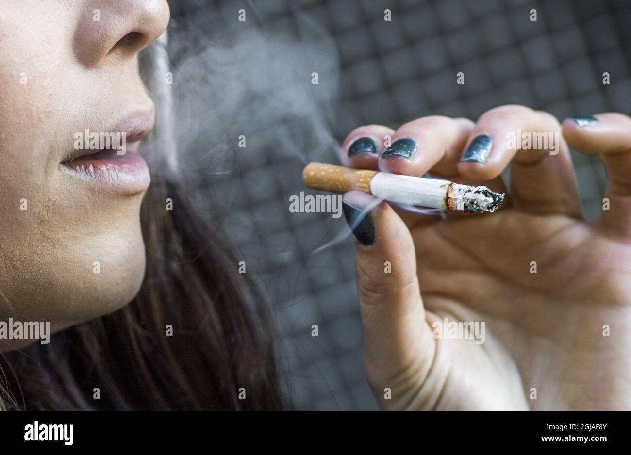 STOCKHOLM 20161206 cigarette, tobacco, smoker, nicotine, woman teenager ...