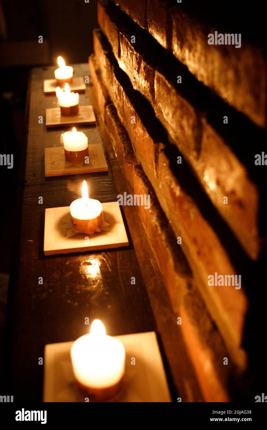 Five candles and brick wall Stock Photo - Alamy