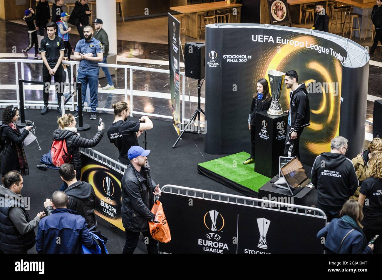 Fans pose with and take pictures of the UEFA Europa League trophy on ...