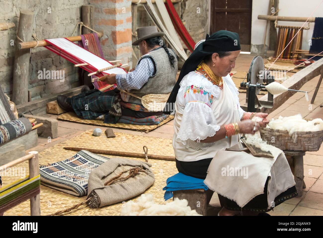 Ecuador, Otavalo. Man at backstrap loom traditional weaving at historic ...