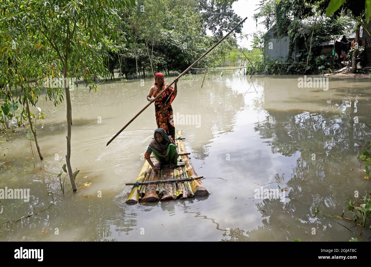 Tarotia, September 9, 202Women paddling on tied palm trees on the river ...