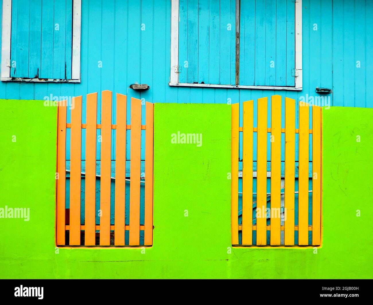 Caribbean, Honduras, Roatan. Brightly painted wall, gates and home on ...