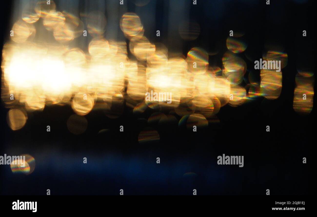 Abstract pattern de-focused points of golden light against the dark ...
