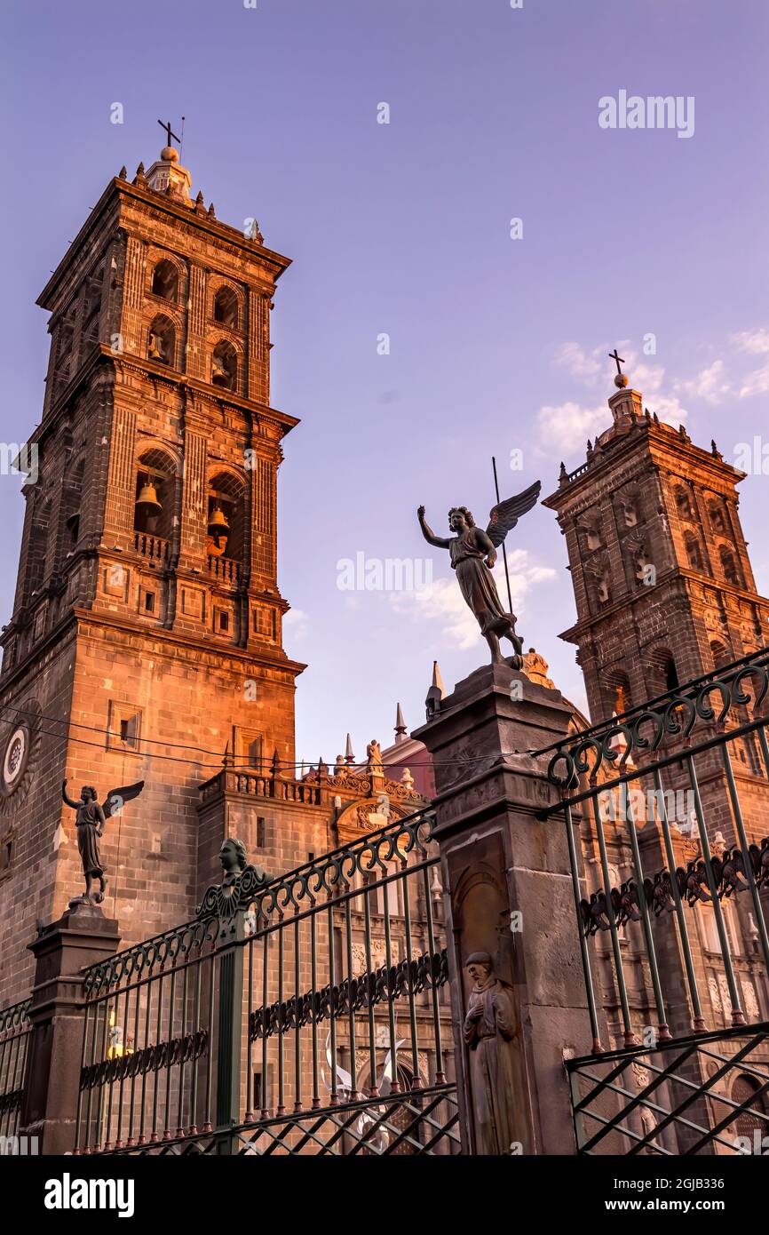 Angel statues outside cathedral at sunset, Puebla, Mexico. Built in 15 ...