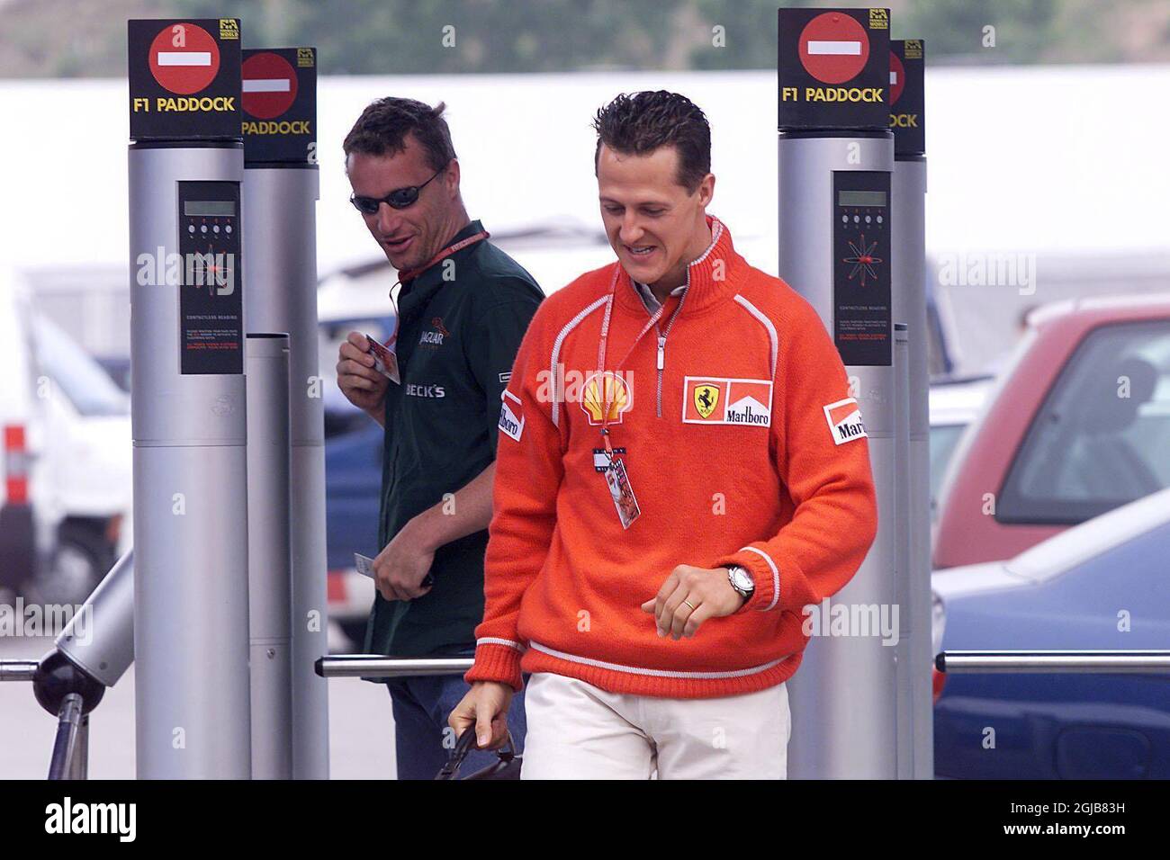 Former teammates Eddie Irvine (l) and Michael Schumacher (r) enter the ...