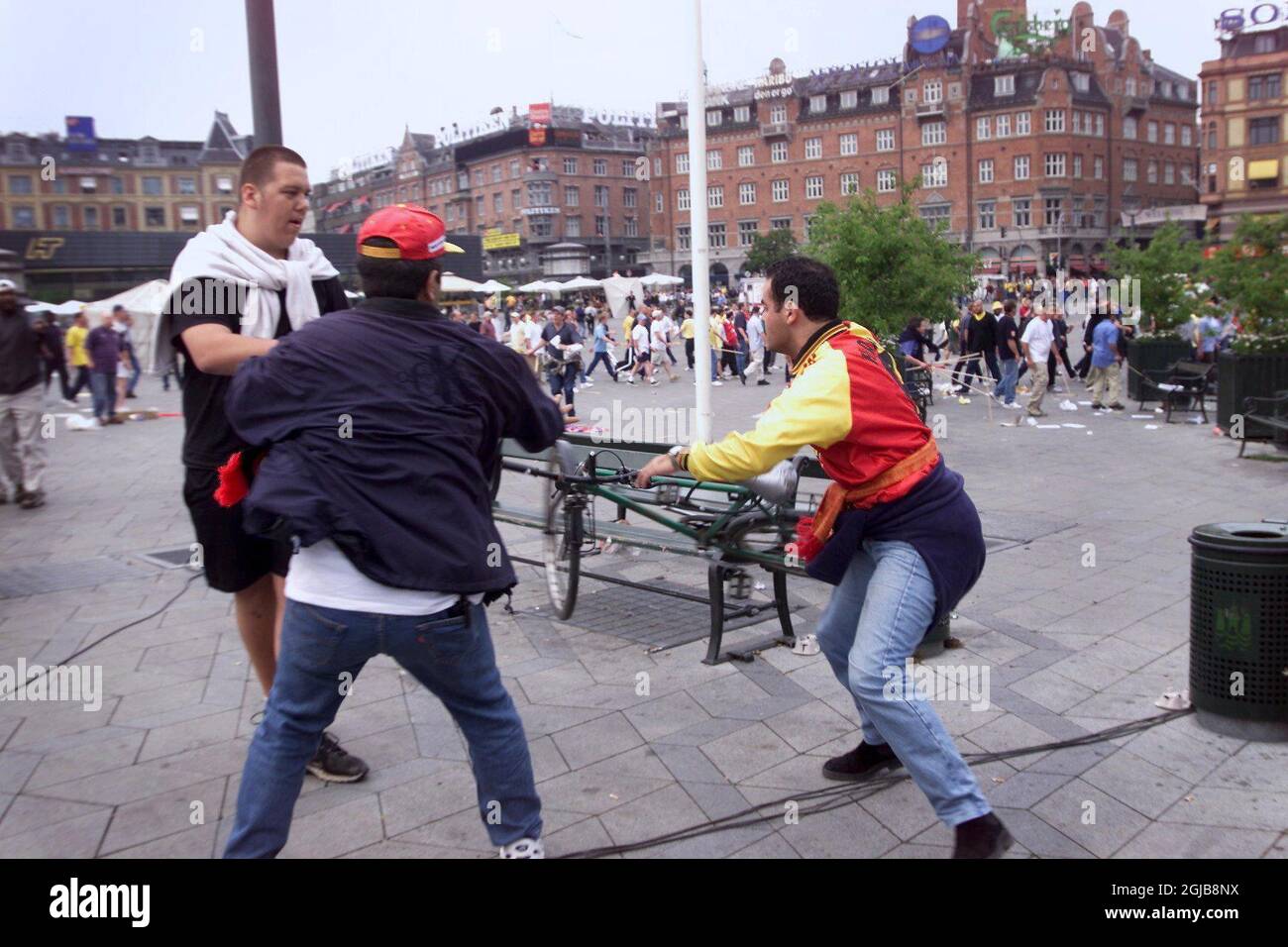 An Arsenal supporter (far left) clashes with two Galatasaray supporters ...