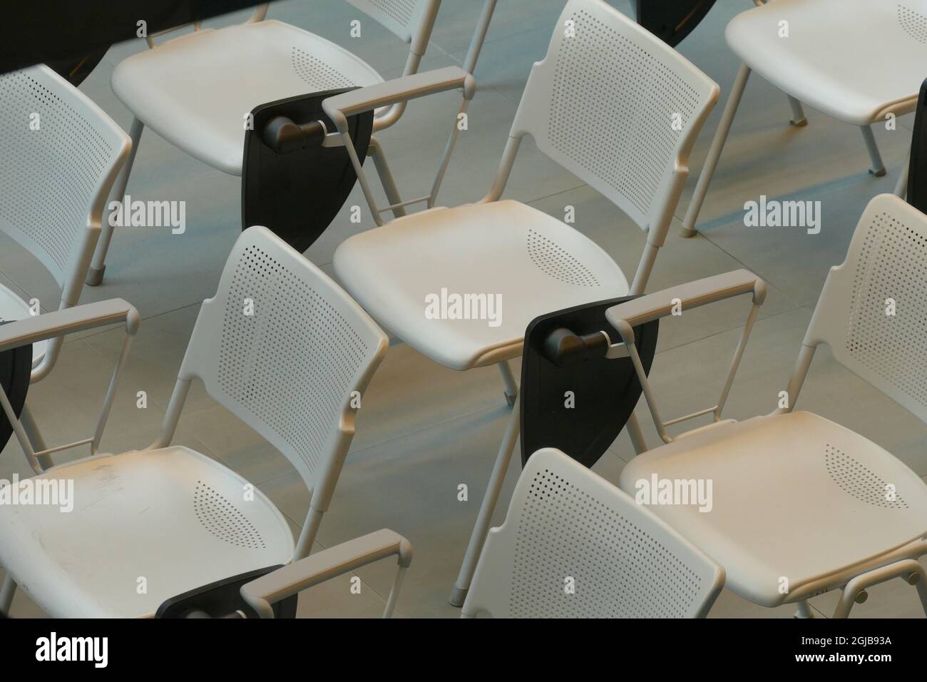 Rows of white seats in a conference room Stock Photo - Alamy