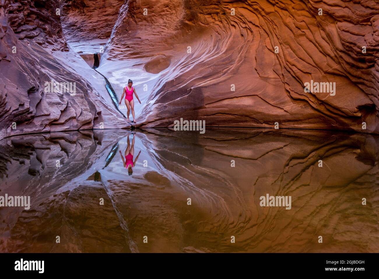 Woman in reflection, anticipating a swim in Red Rock Oasis, Grand ...