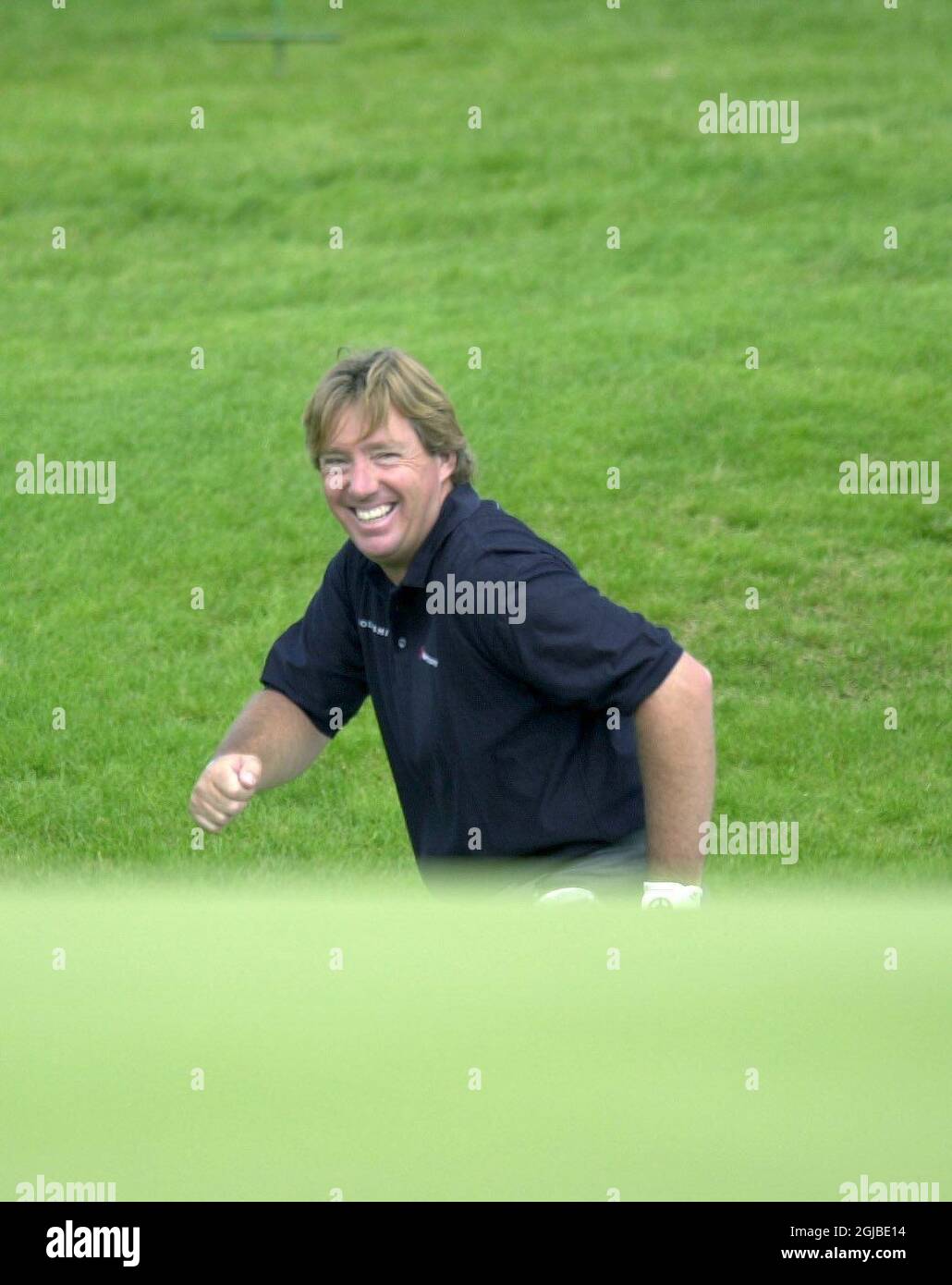 Barry Lane celebrates at the 13th hole after seeing his bunker shot go ...
