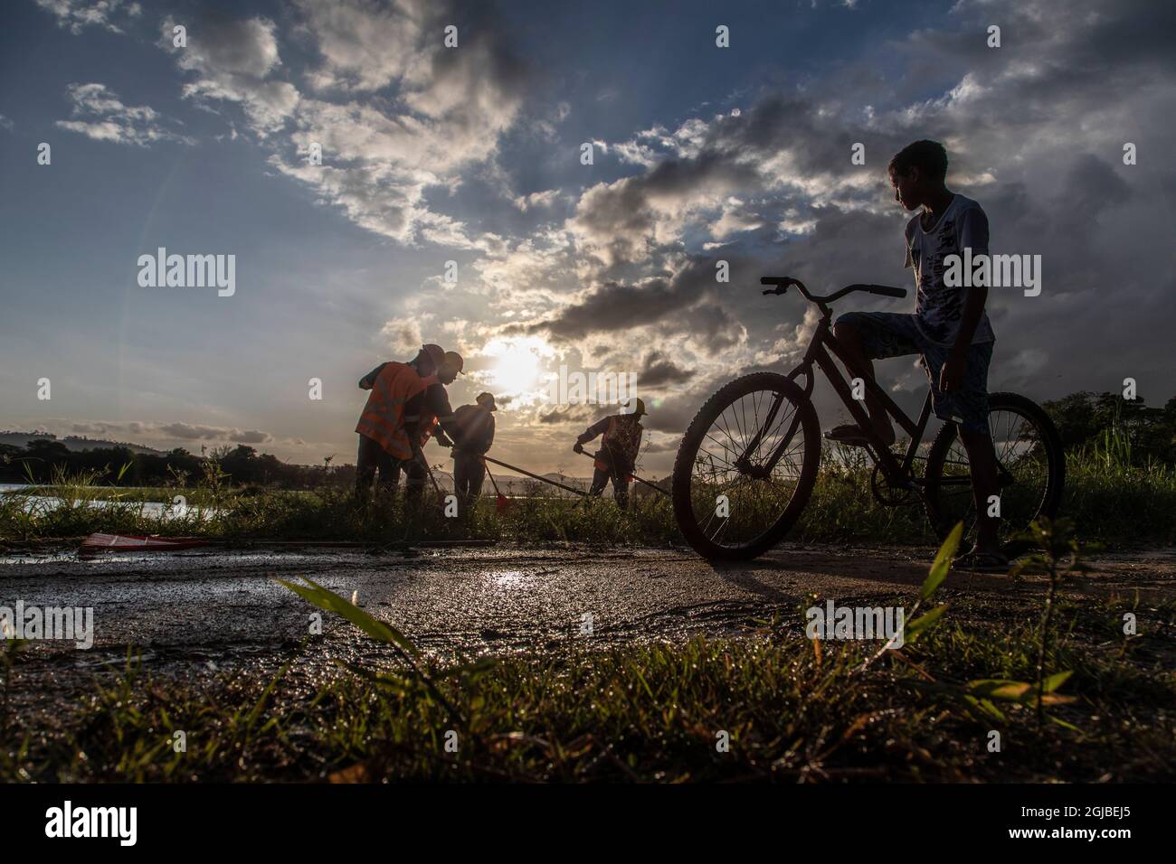boy with bike watching workers Stock Photo - Alamy